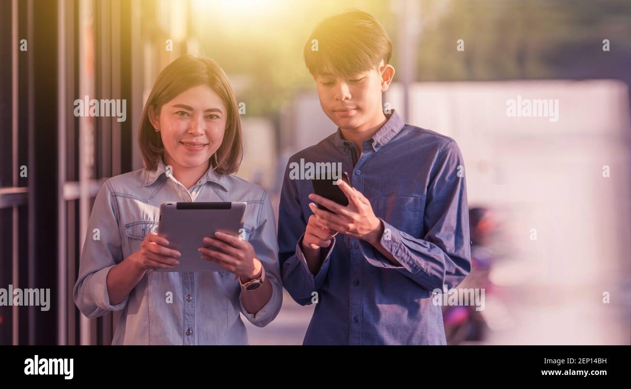 People using tablet and smartphone talking business Stock Photo - Alamy