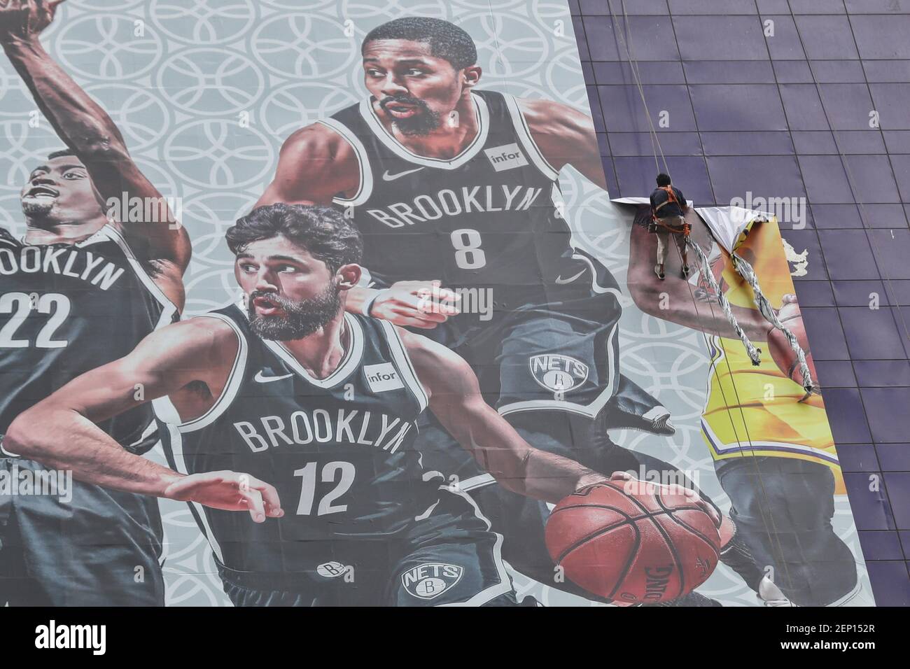The workers are removing poster of "2019 NBA China Game" in Shanghai ...