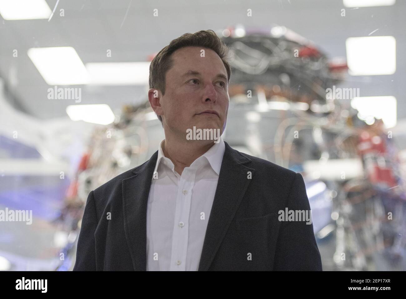 SpaceX Chief Engineer Elon Musk speaks to media in front of Crew Dragon ...