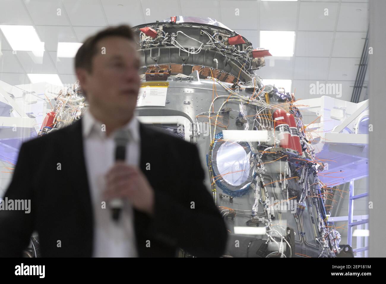 SpaceX Chief Engineer Elon Musk speaks to media in front of Crew Dragon ...