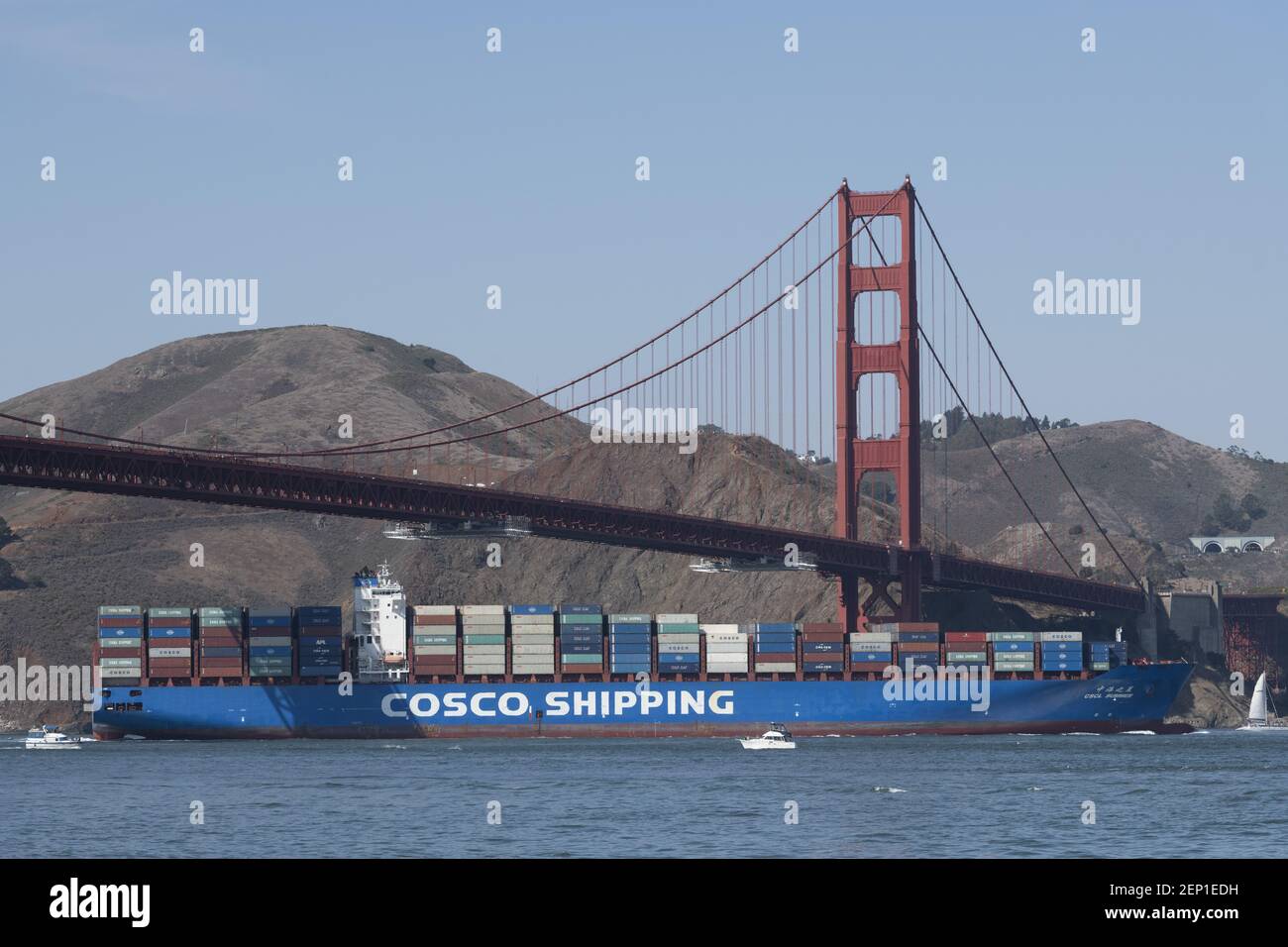 A cargo container ship sails under the Golden Gate Bridge in San ...
