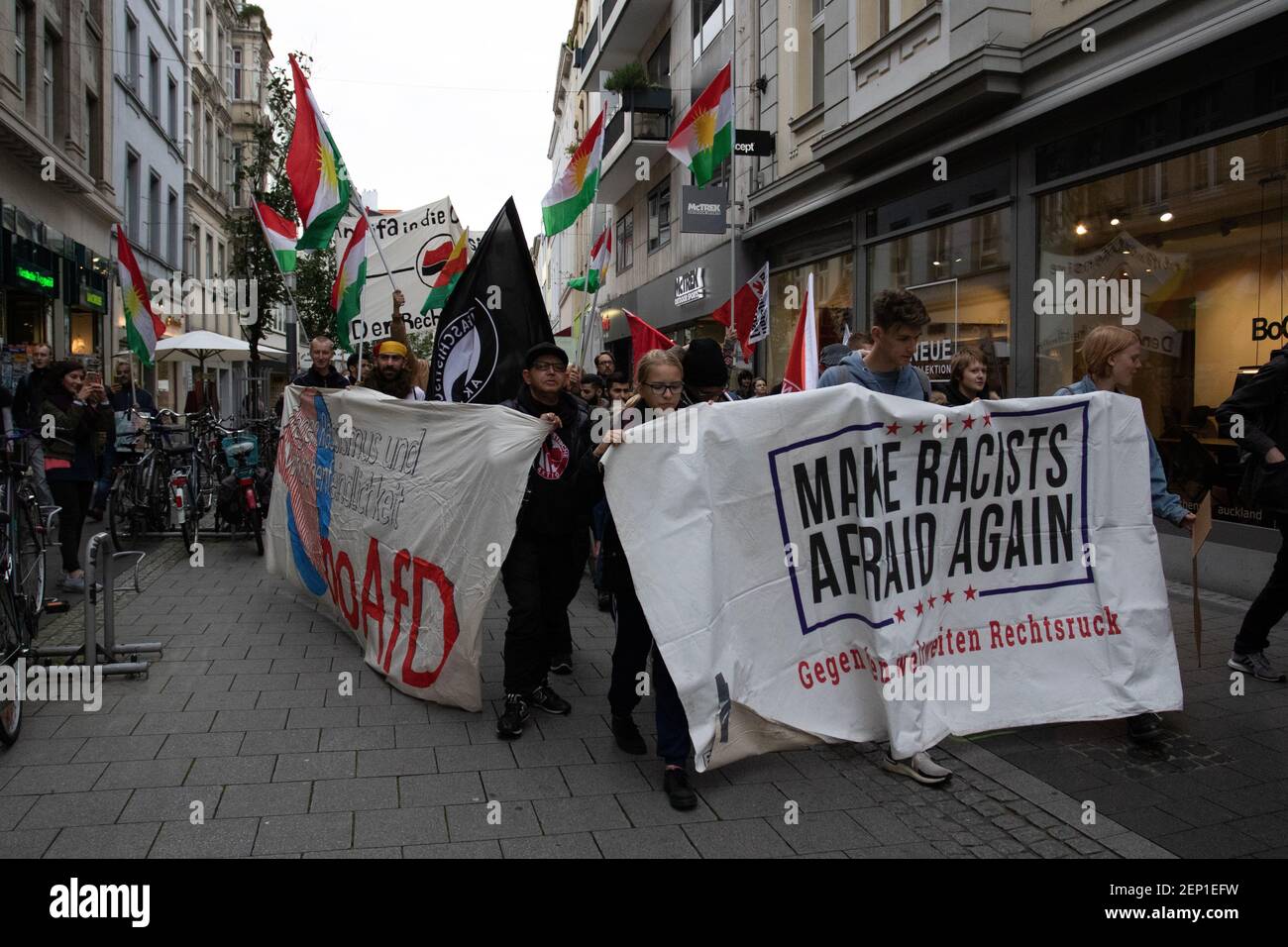 Protesters hold banners with a slogan against racism during the ...