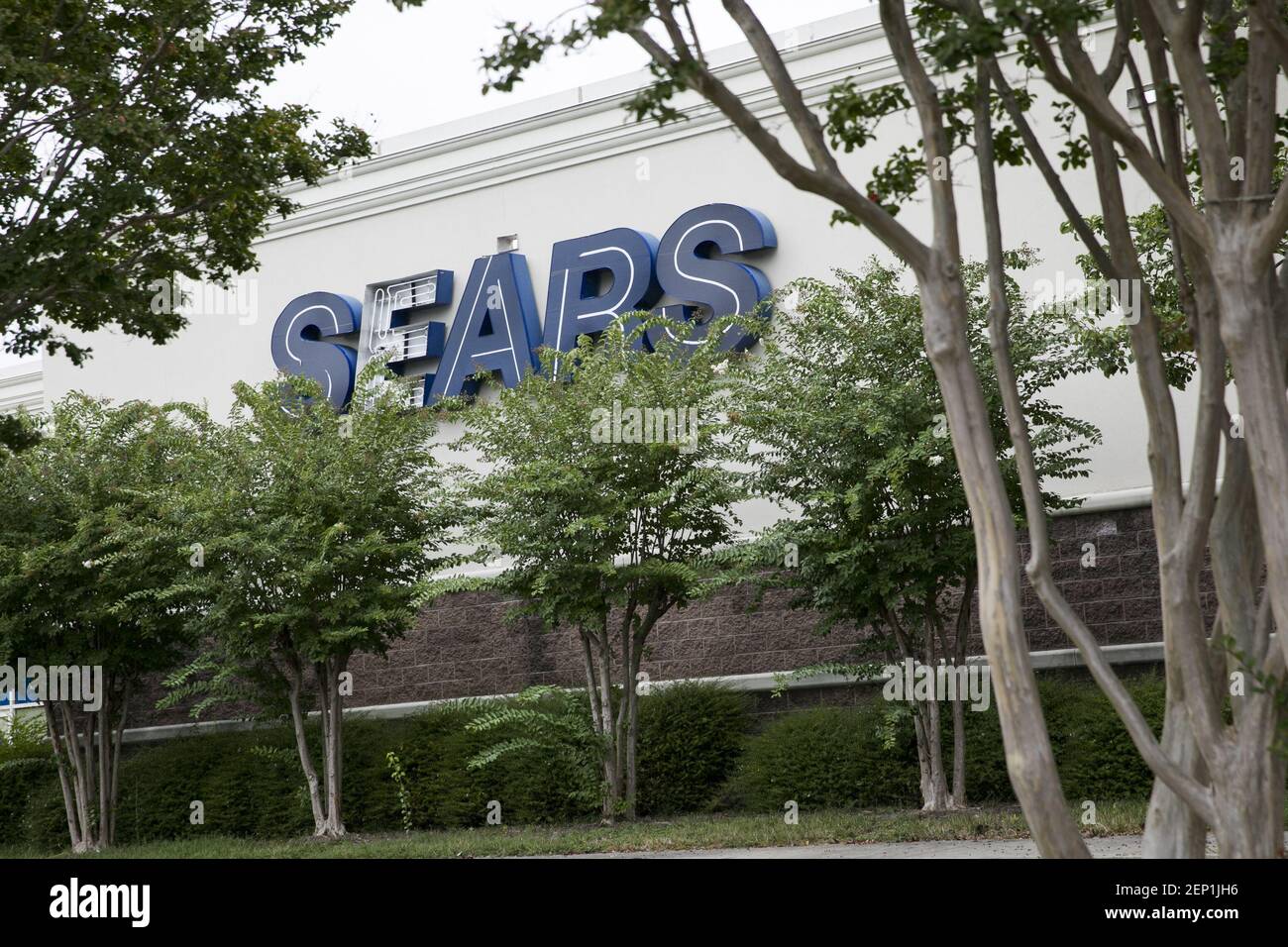 A logo sign outside of a closed Sears retail store location in Glen ...