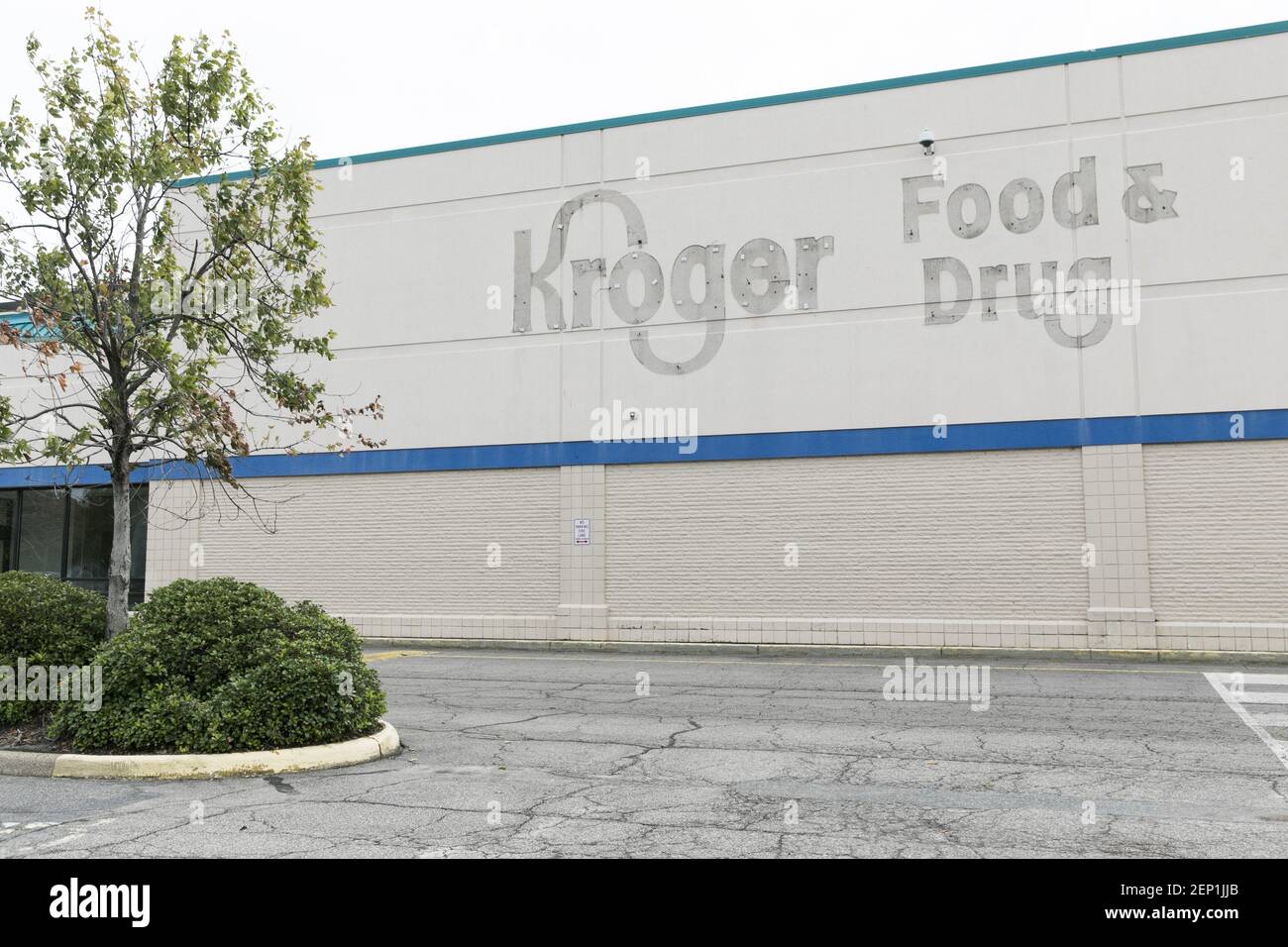 The outline of a logo sign outside of a closed Kroger retail grocery ...