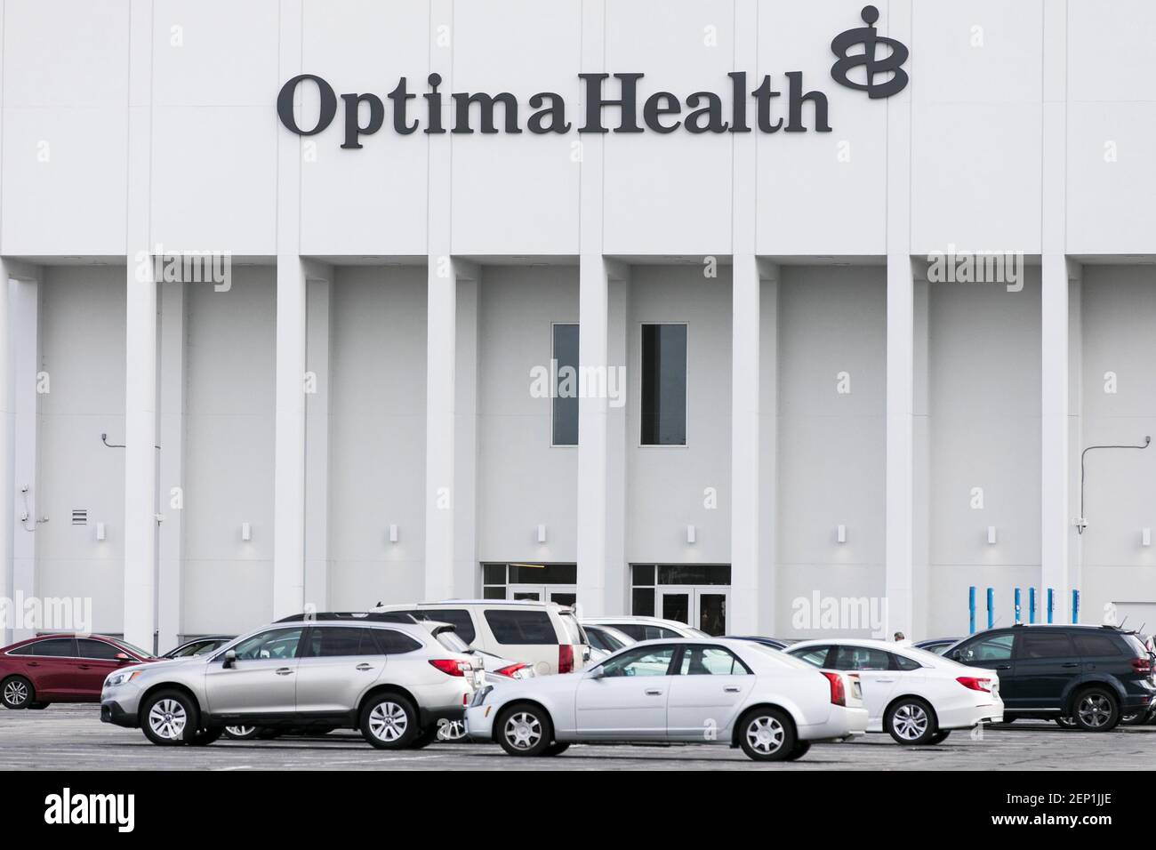 A logo sign outside of a facility occupied by Optima Health in Norfolk ...