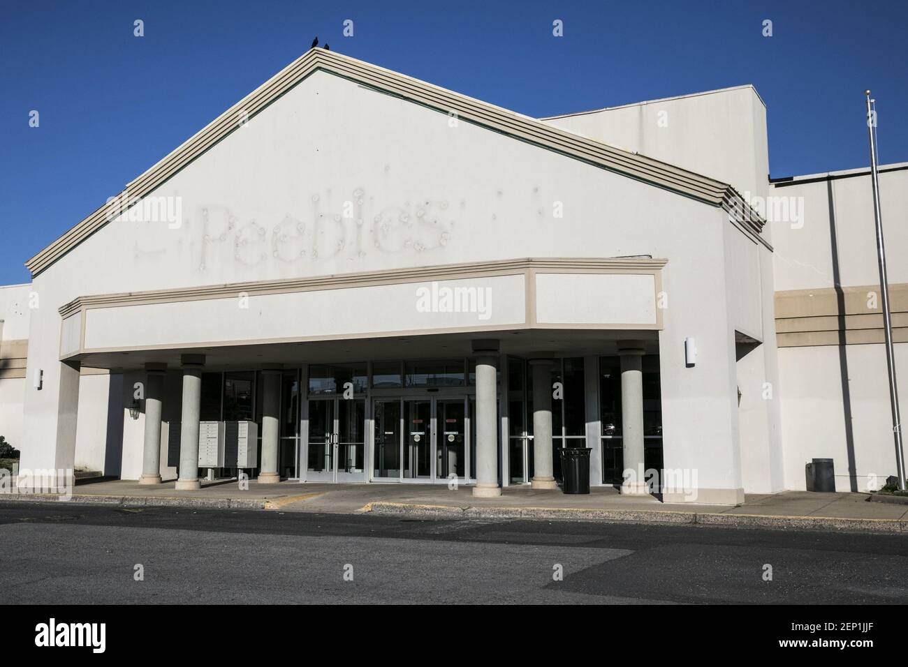 The faded outline of a logo sign outside of a closed and abandoned ...