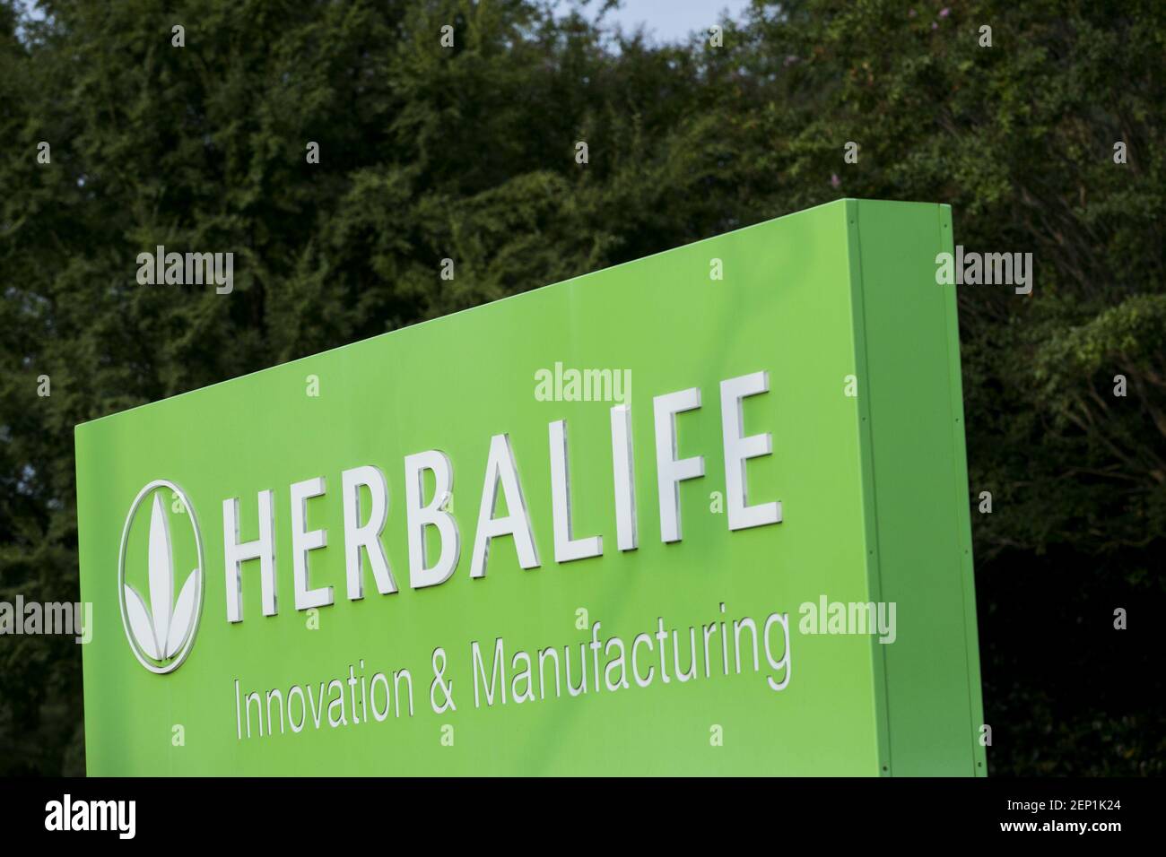 A logo sign outside of a facility occupied by Herbalife in Winston ...