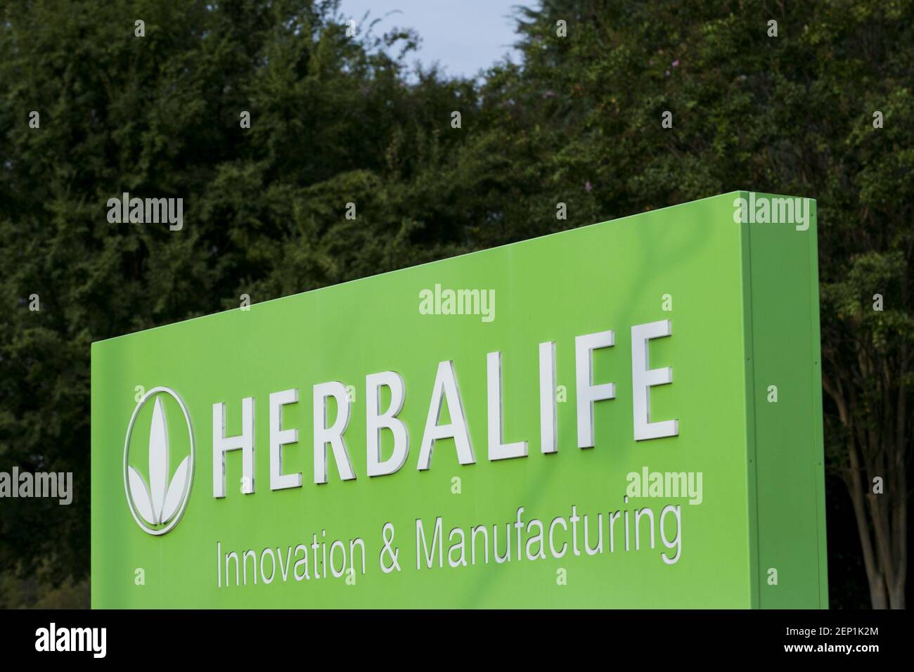 A logo sign outside of a facility occupied by Herbalife in Winston ...