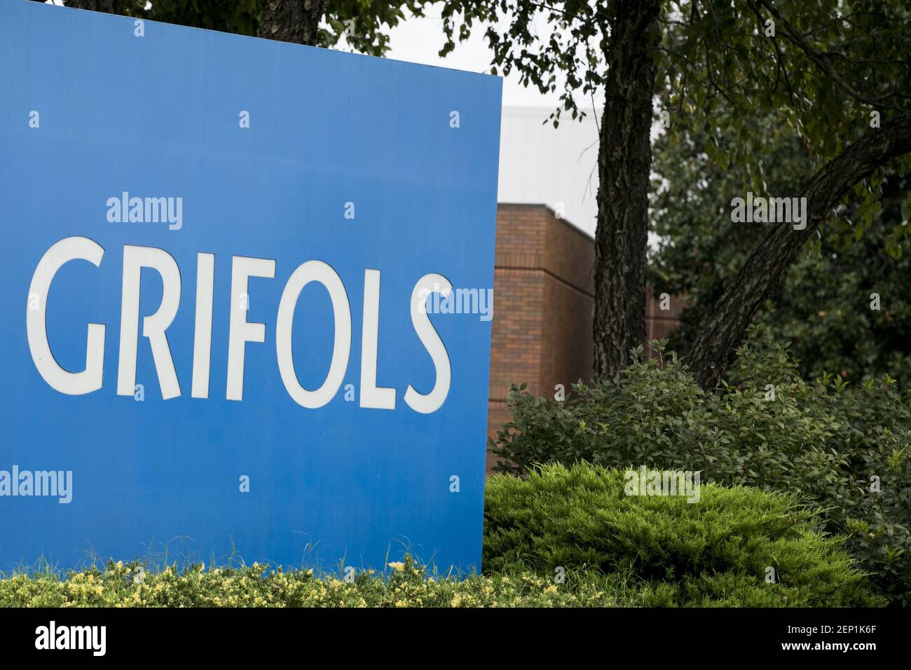 A logo sign outside of a facility occupied by Grifols in Clayton, North ...