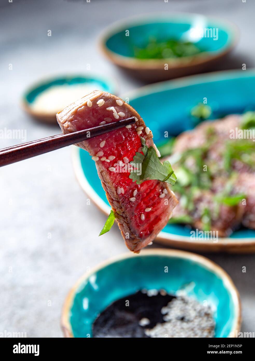 Beef tataki with sauce and sesame on blue plate. Japanese food Stock ...