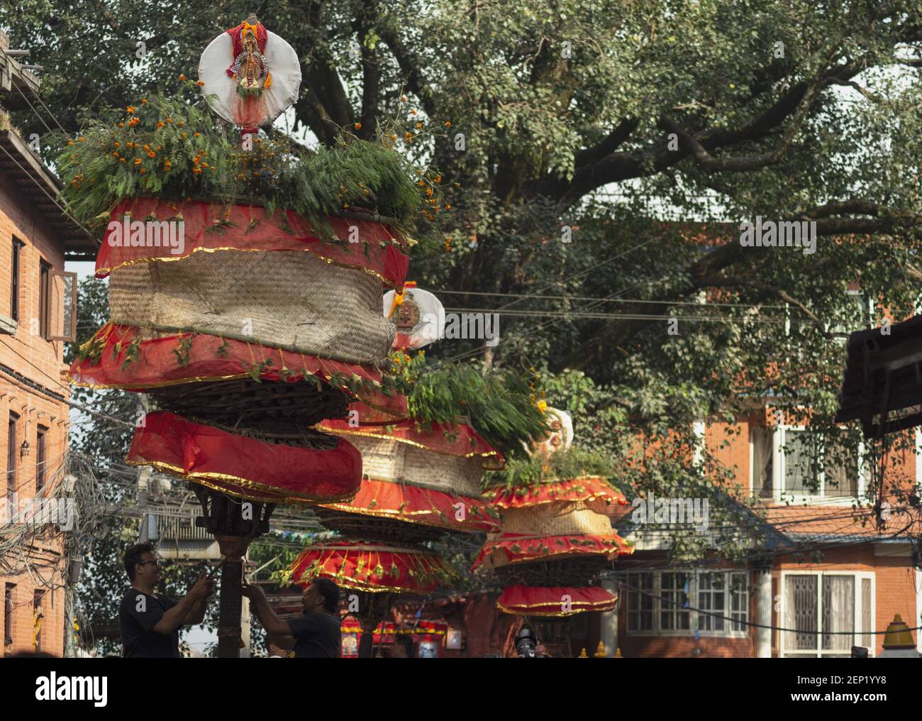 Devotees rotate the top part of a chariot of Lord Narayan during the ...