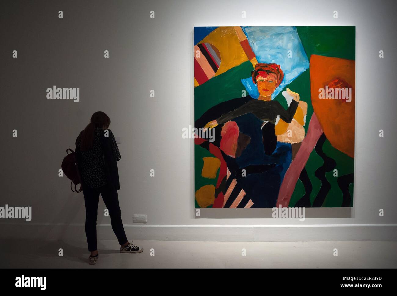 A visitor looks at a painting during the exhibition. 'Eleuthera' is an ...