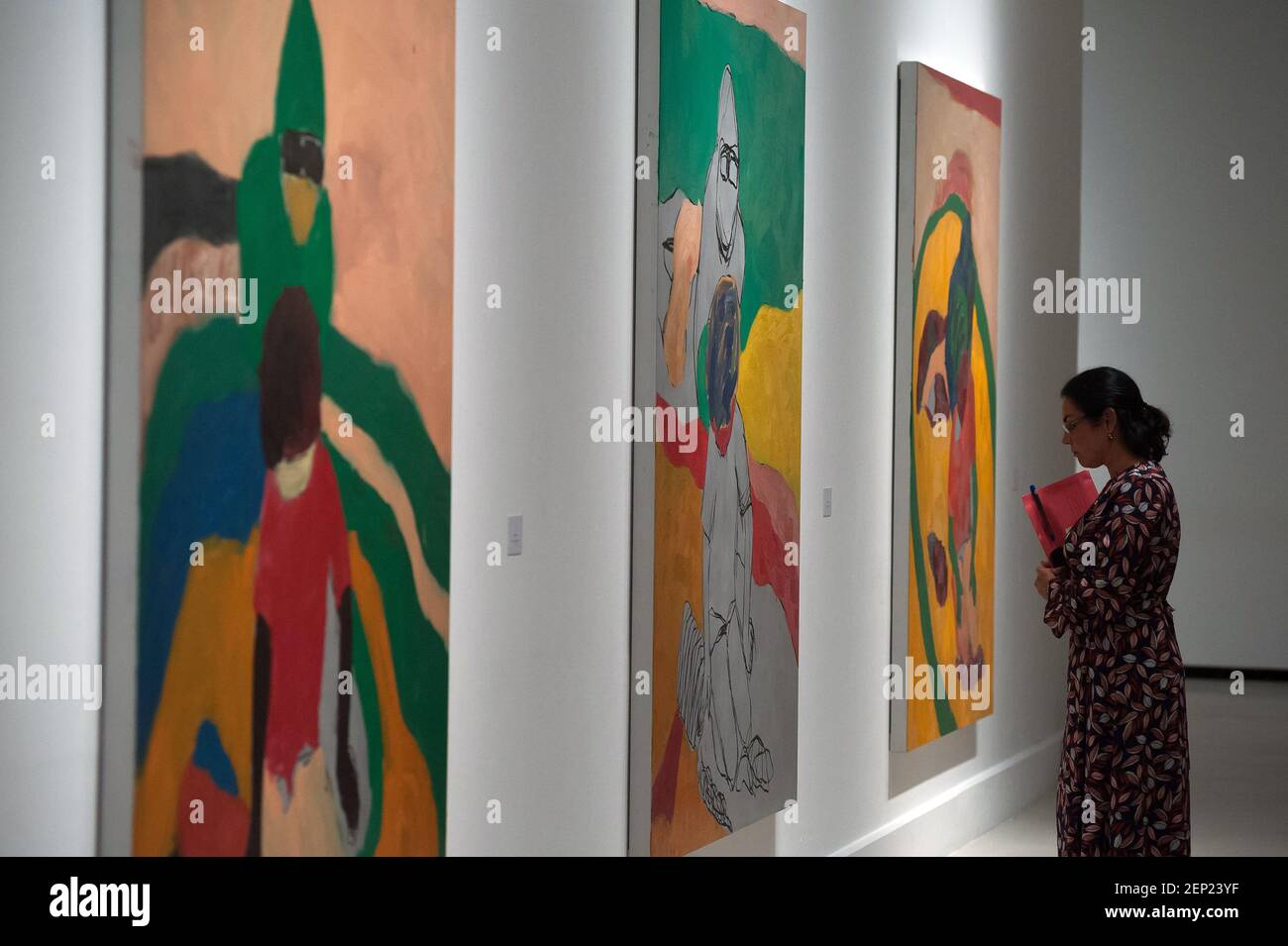A visitor looks at a painting during the exhibition. 'Eleuthera' is an ...