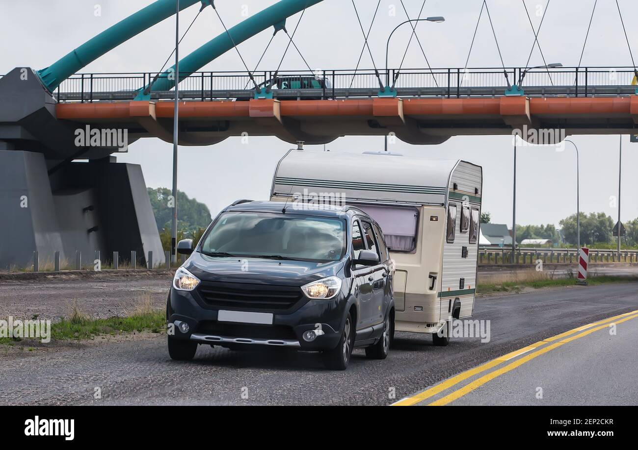 car with a camping trailer moving on the highway Stock Photo - Alamy