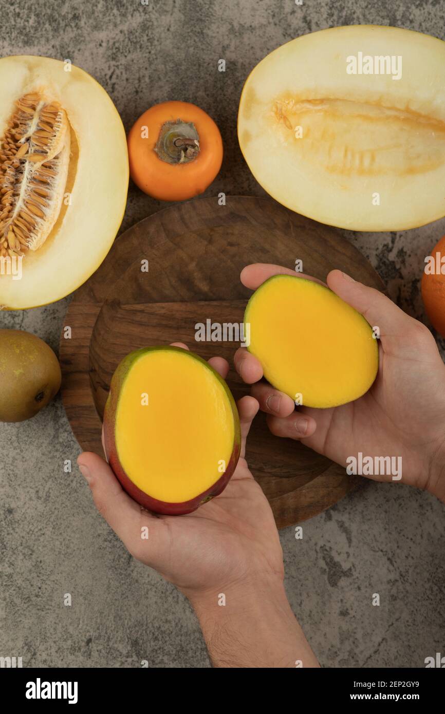 Hand man holding mango hi-res stock photography and images - Alamy