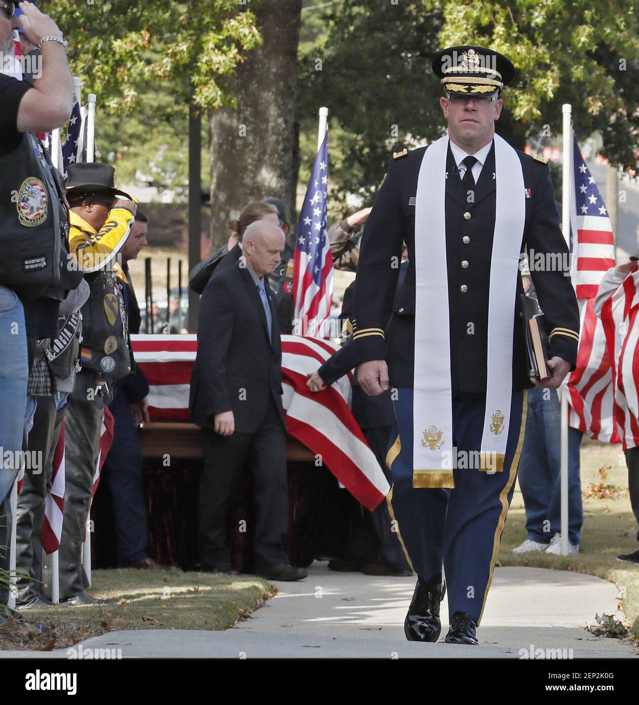 A Chaplain leads the procession as pall bearers carry the casket into ...