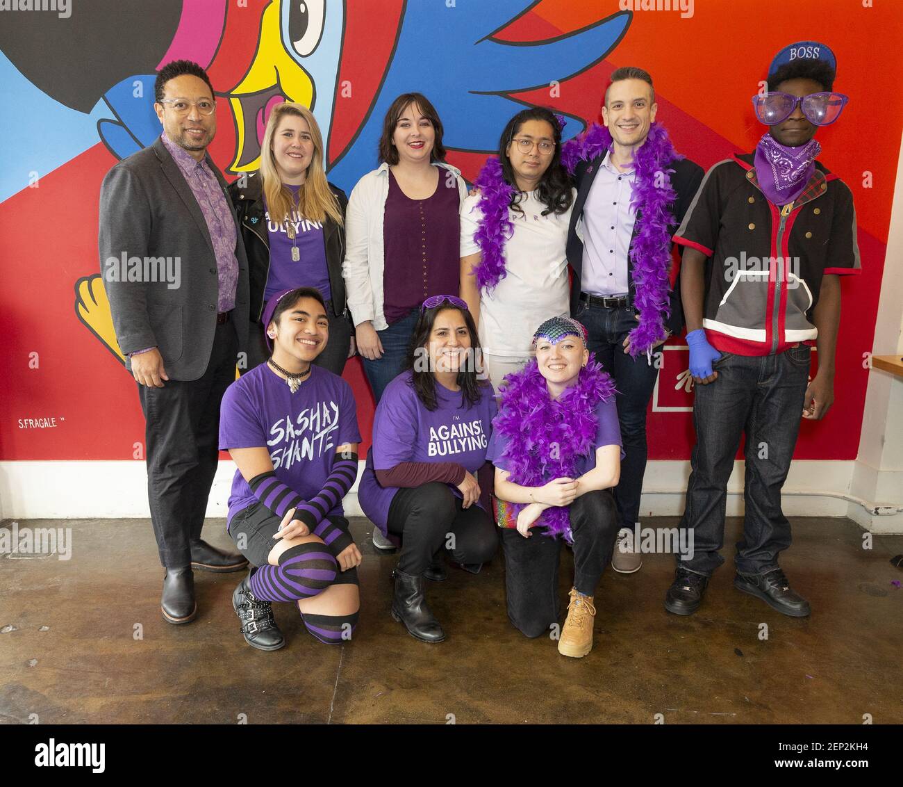 Group of volunteers pose during Spirit Day in support of GLAAD LGBTQ ...