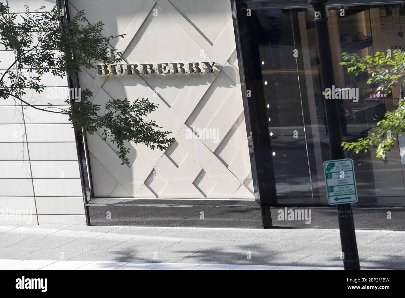 A logo sign outside of a Burberry retail store location in downtown ...