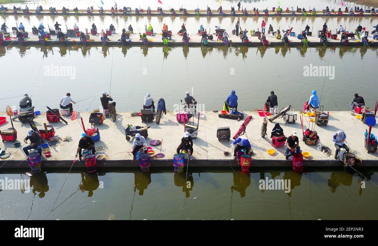Chinese anglers compete during an angling contest at a fish farm in ...