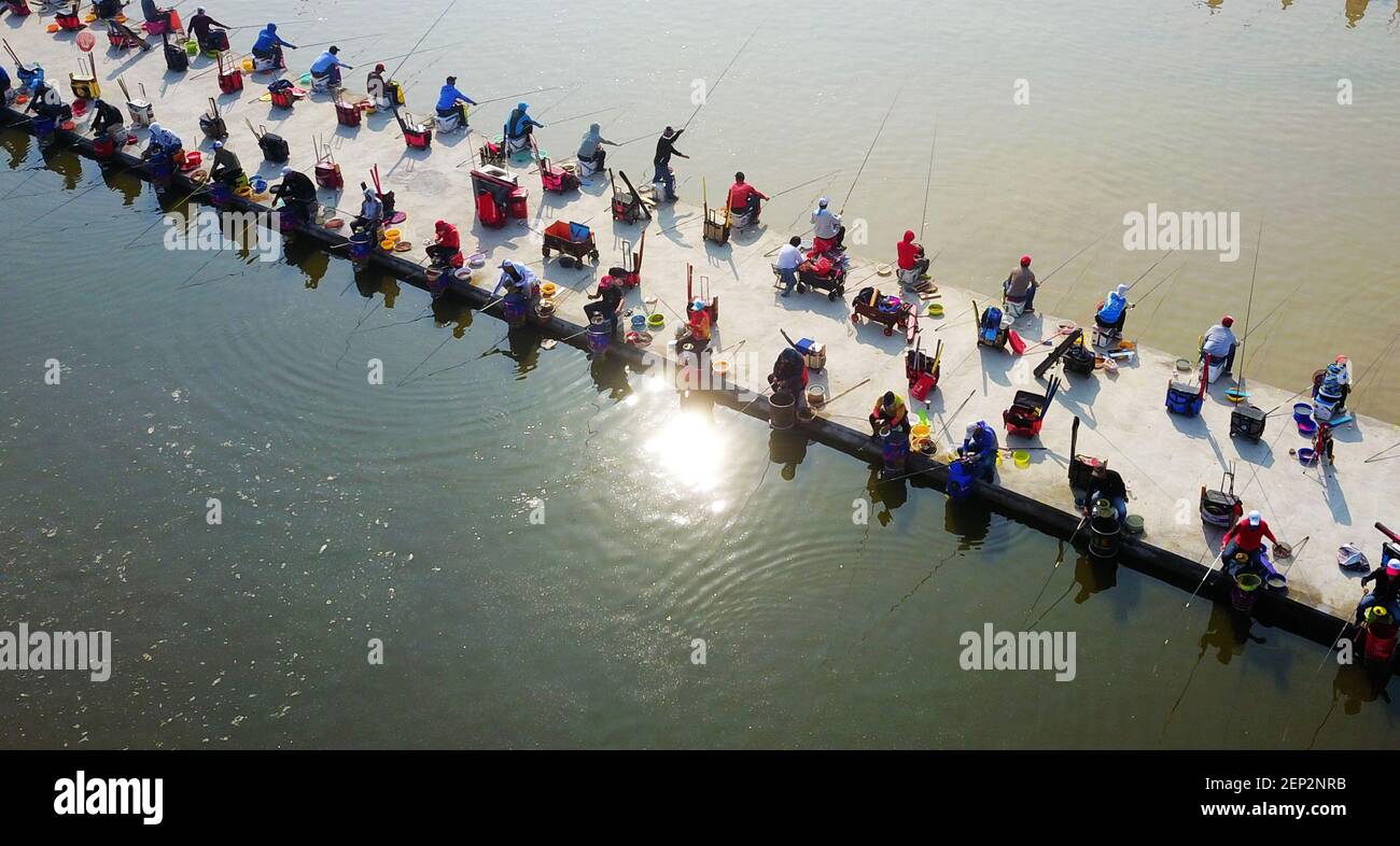 Chinese anglers compete during an angling contest at a fish farm in ...