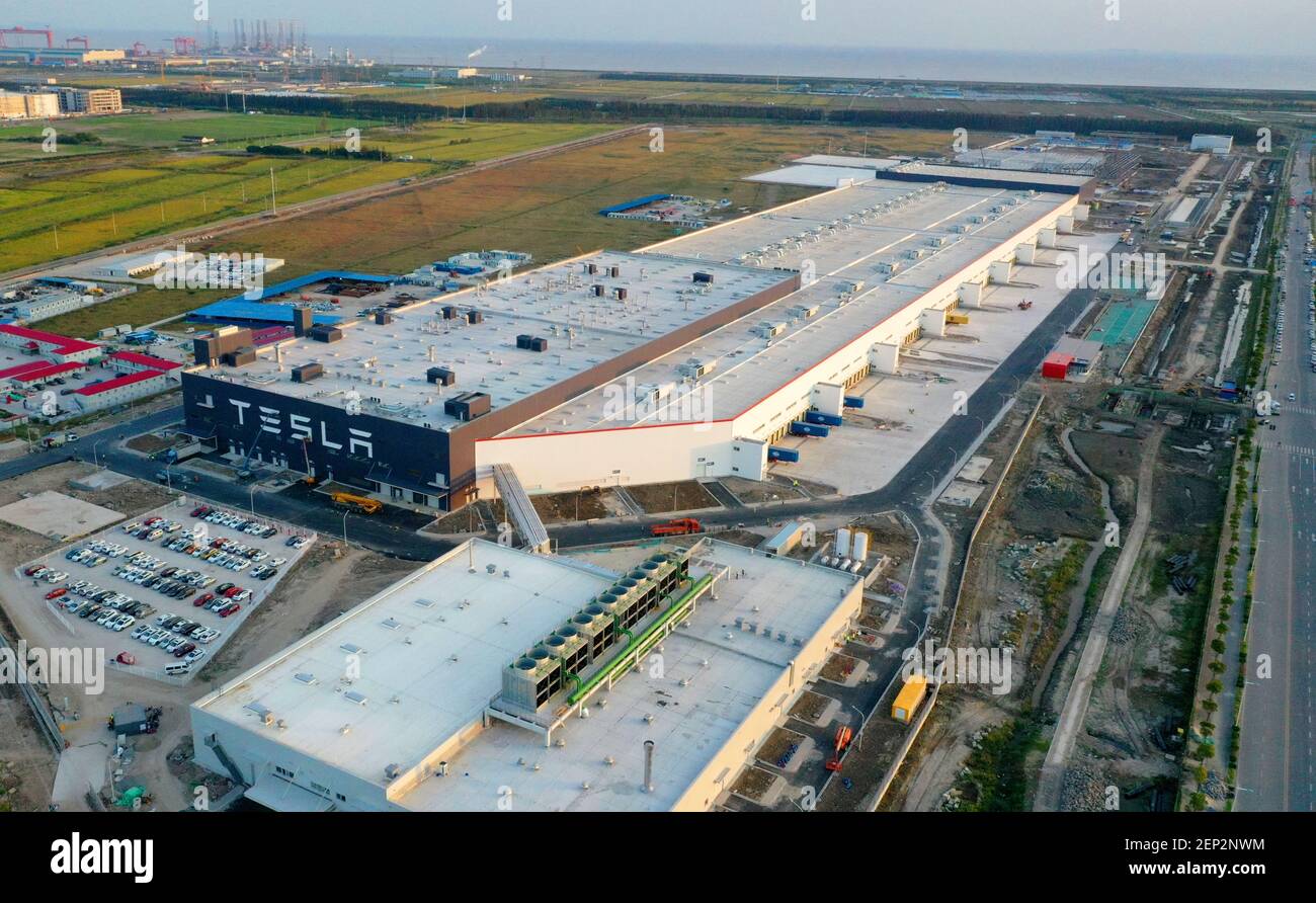 Chinese workers install the logo of TESLA on the facade of the Tesla ...