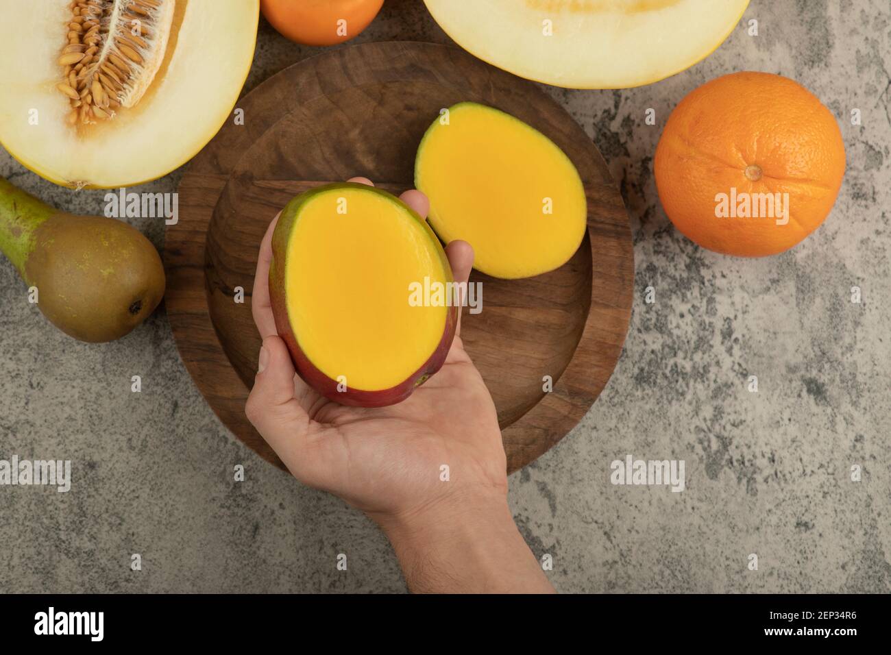 Hand man holding mango hi-res stock photography and images - Alamy