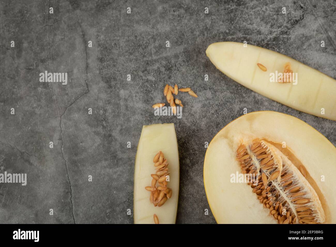 Half cut fresh sweet melon placed on marble surface Stock Photo - Alamy