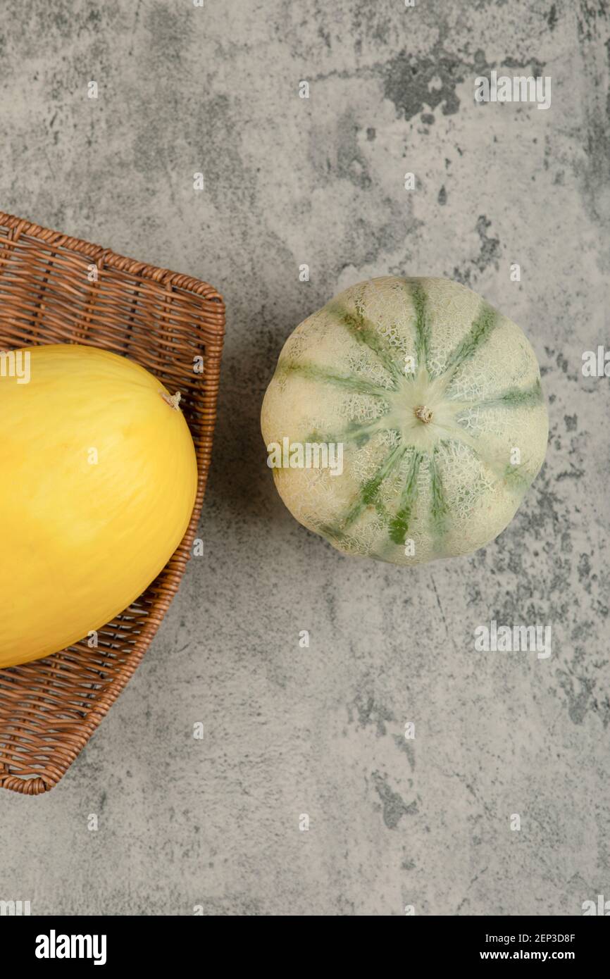 Yellow fresh melon and green cantaloupe on marble table Stock Photo - Alamy