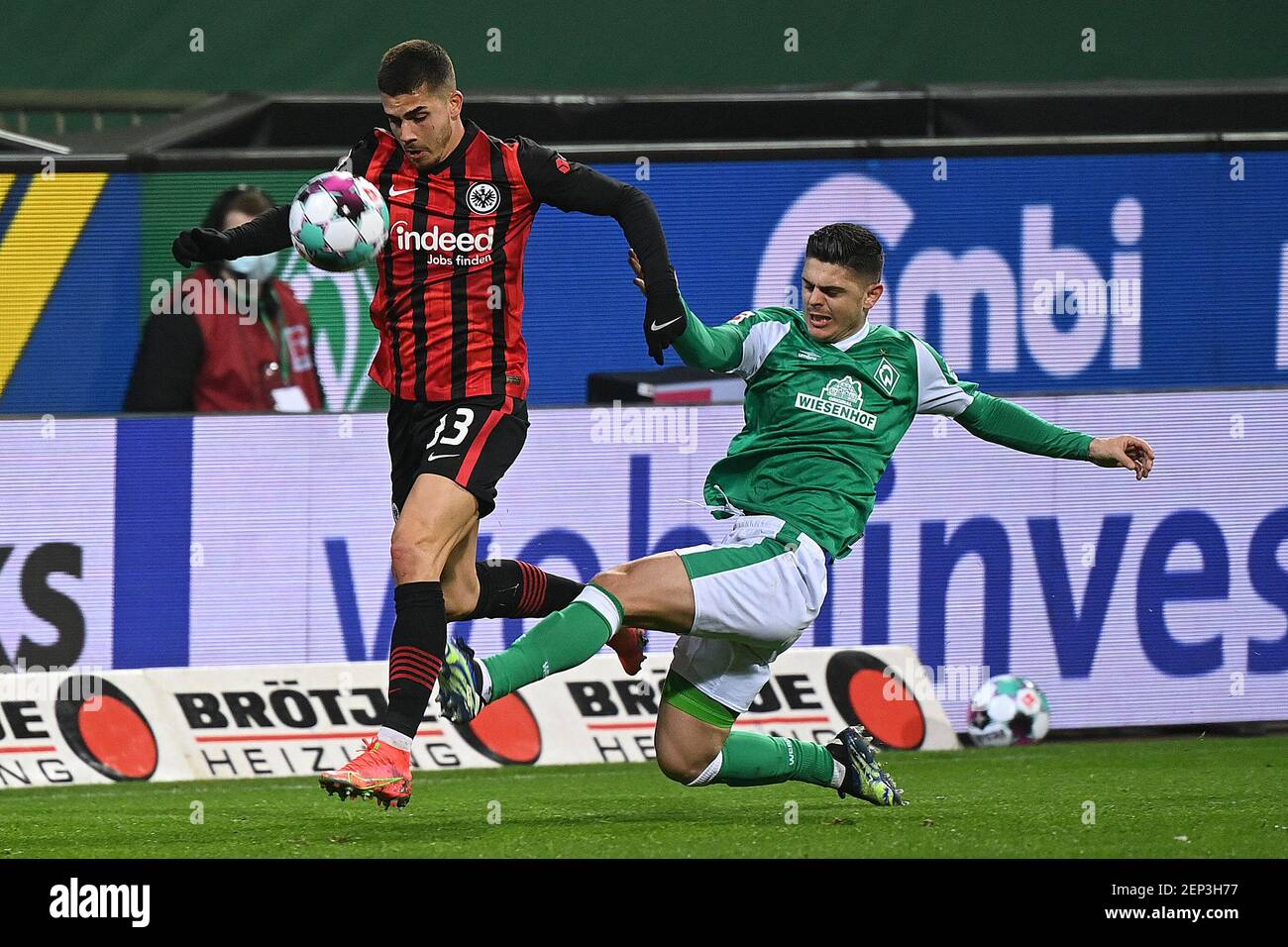 Bremen, Germany. 26th Feb, 2021. Andre Silva (L) of Frankfurt vies with ...