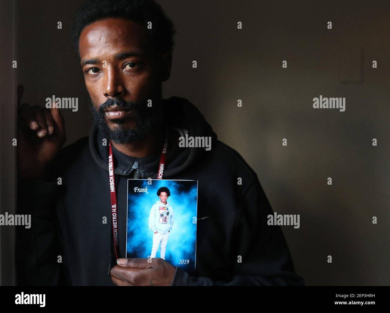 Frank Looney poses for a photograph with a picture of his son, Frank ...