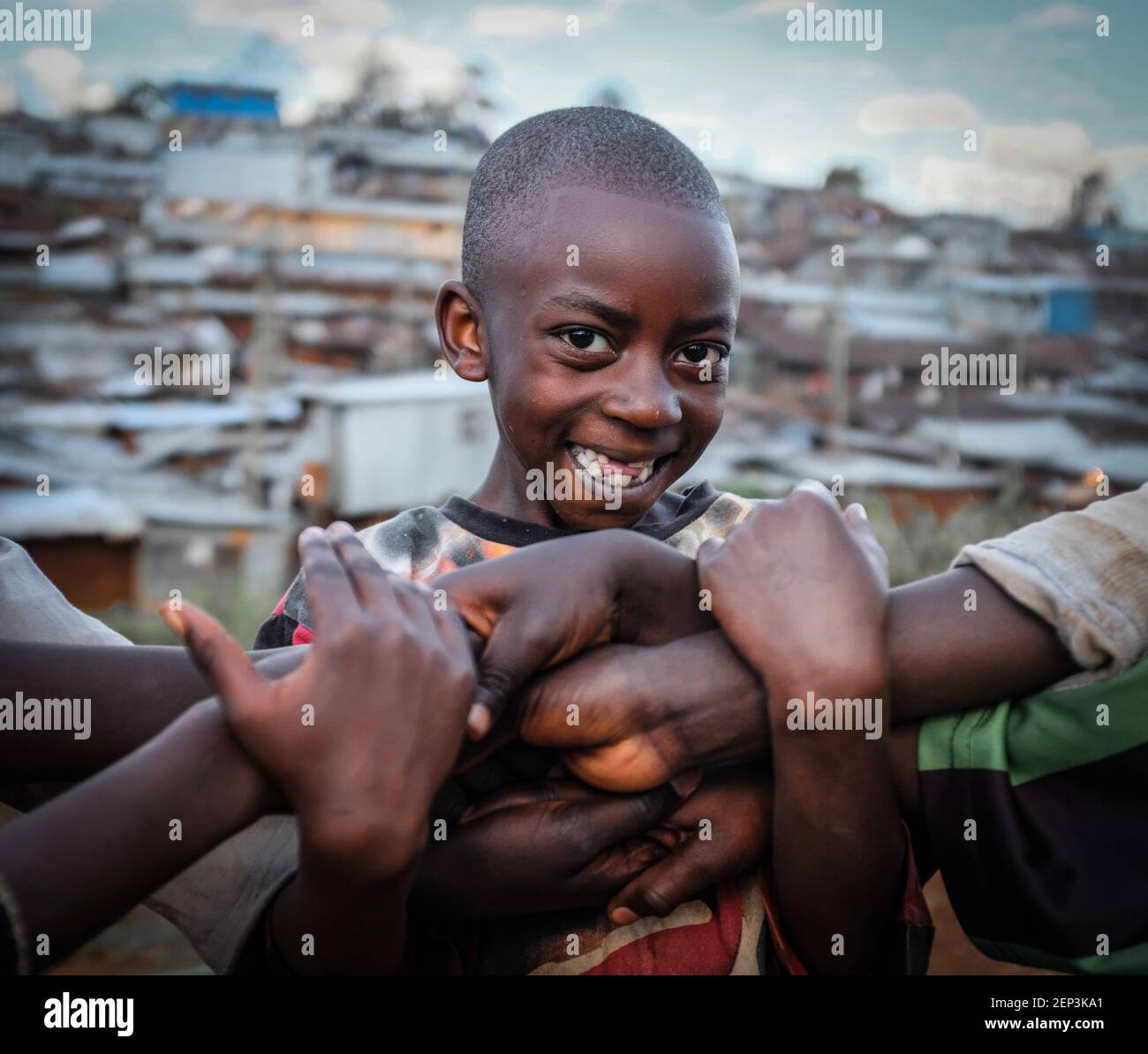 A kid poses with joined hands in Kibera slums. Inside Africa’s largest ...