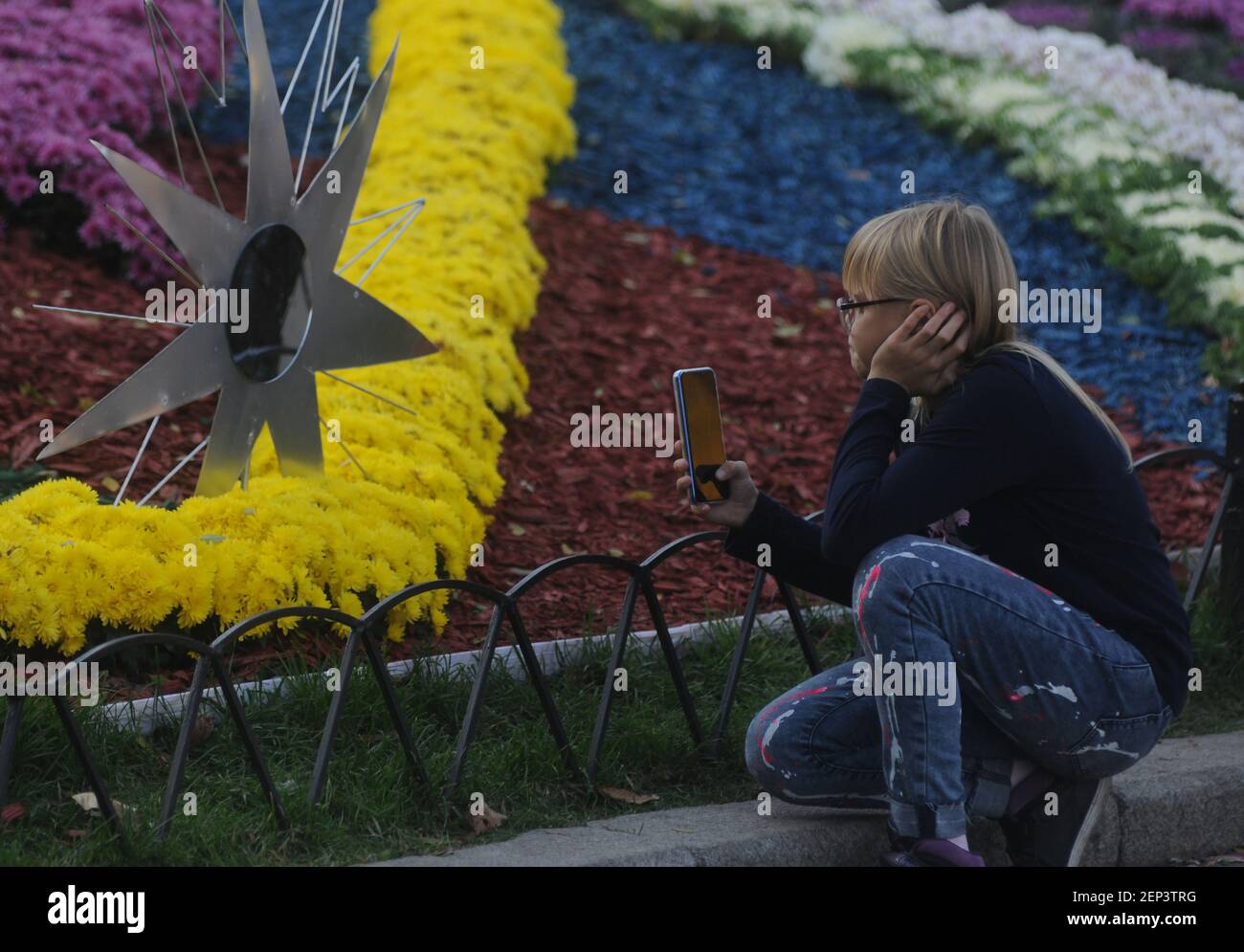 A woman takes a photo during the Flower Constellation Chrysanthemum ...