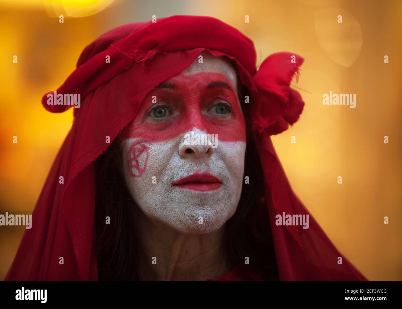 An extinction rebellion activist with face paint during the ...