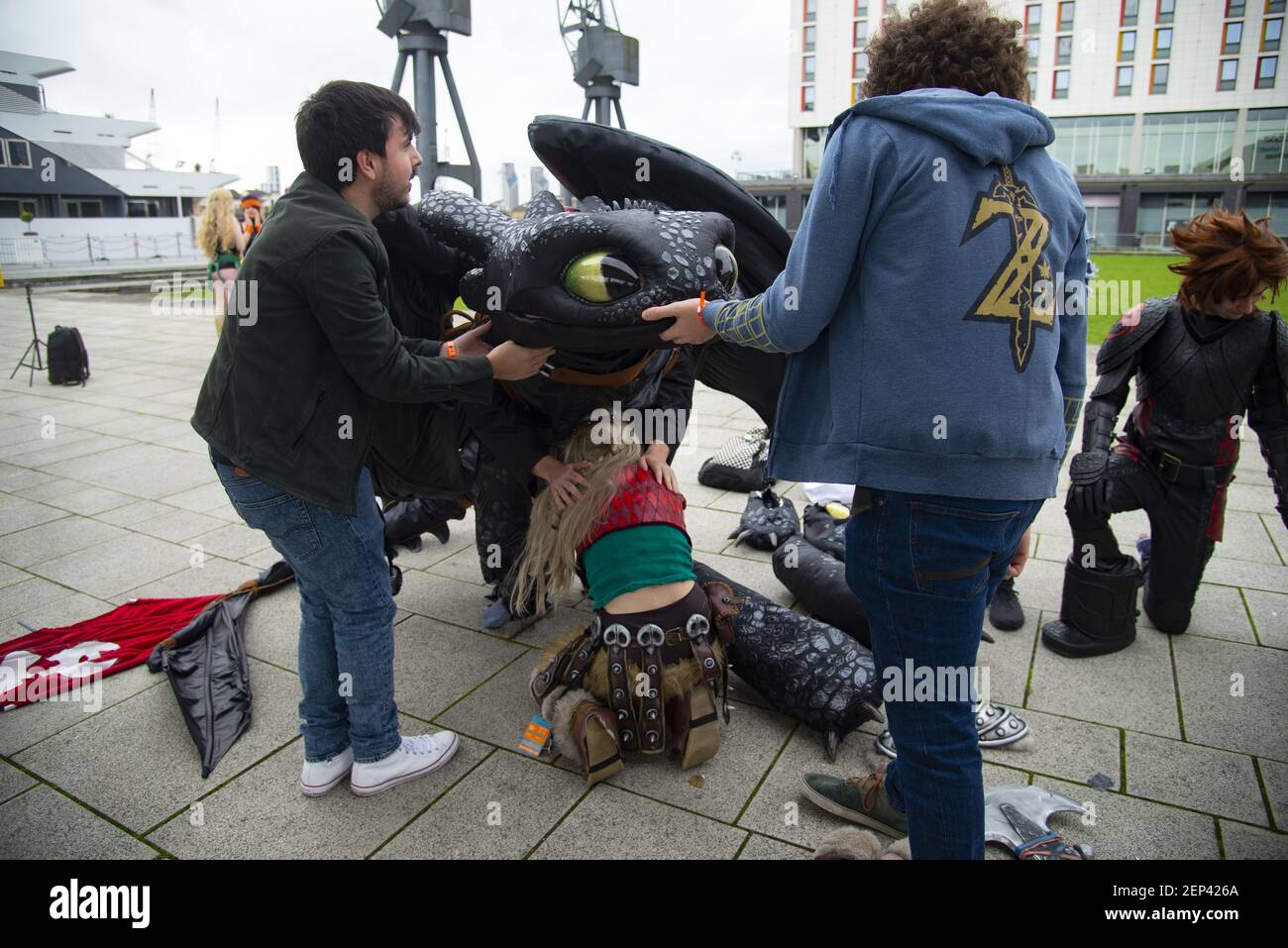 A fan is helped into his costume as fans of comic books dressed as ...