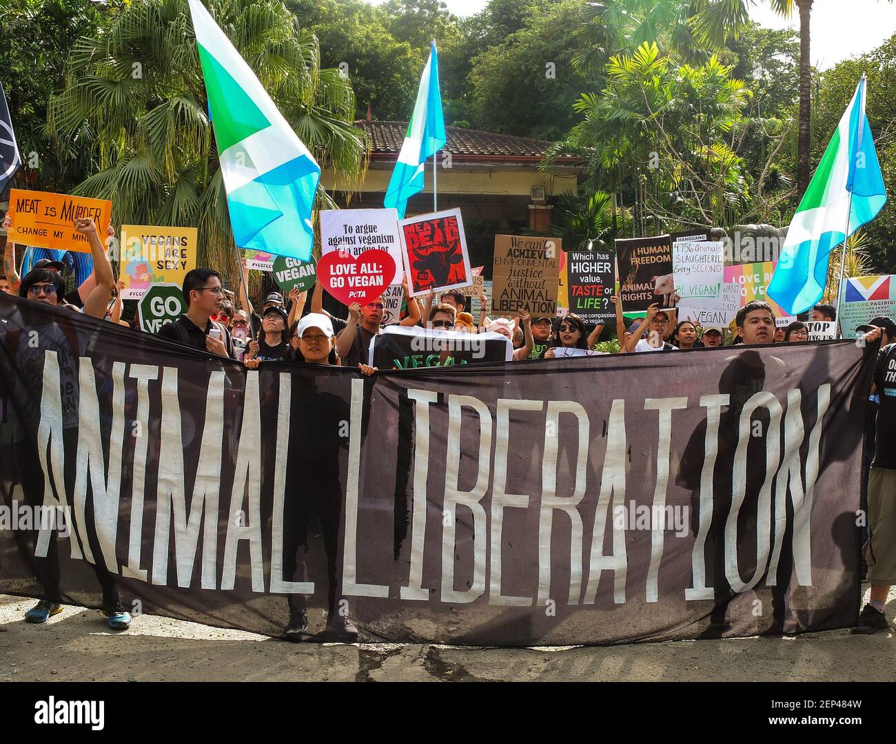 Vegans and animal rights advocates hold a banner and placards during ...