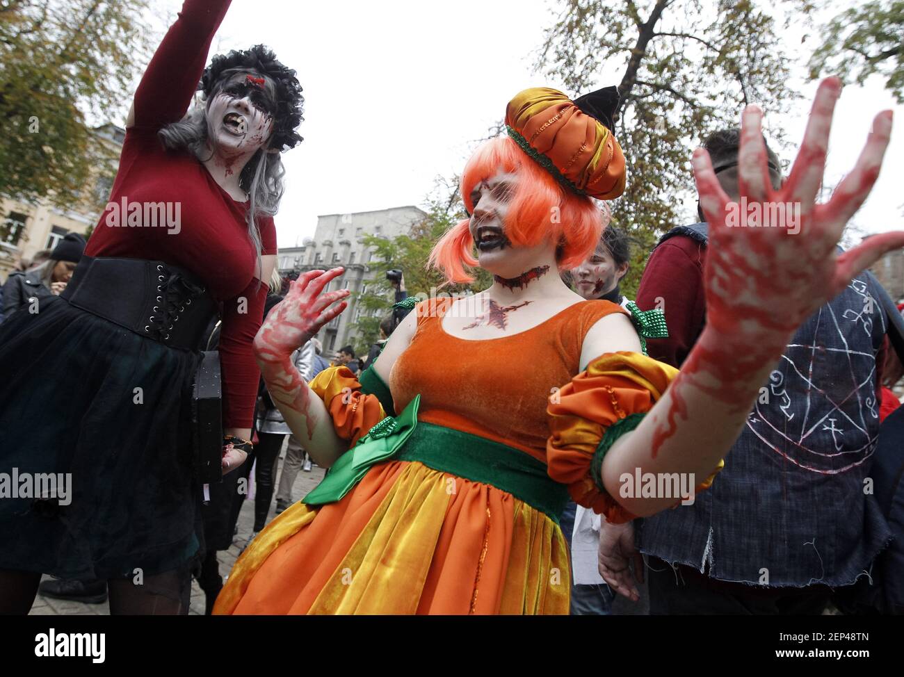 Participants wearing make-up and zombie costumes attend the Halloween ...
