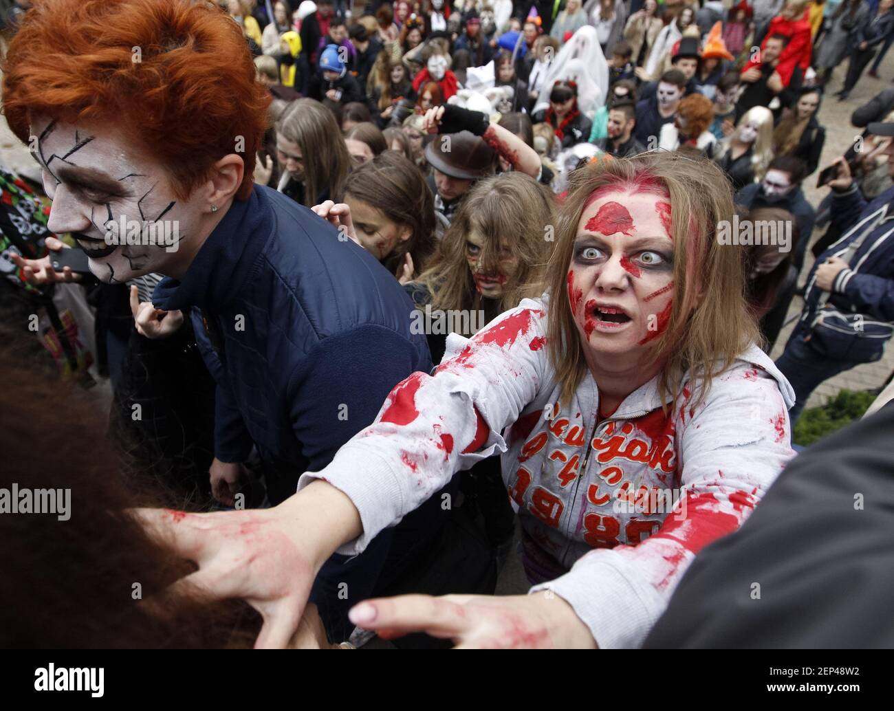 Participants wearing make-up and zombie costumes attend the Halloween ...