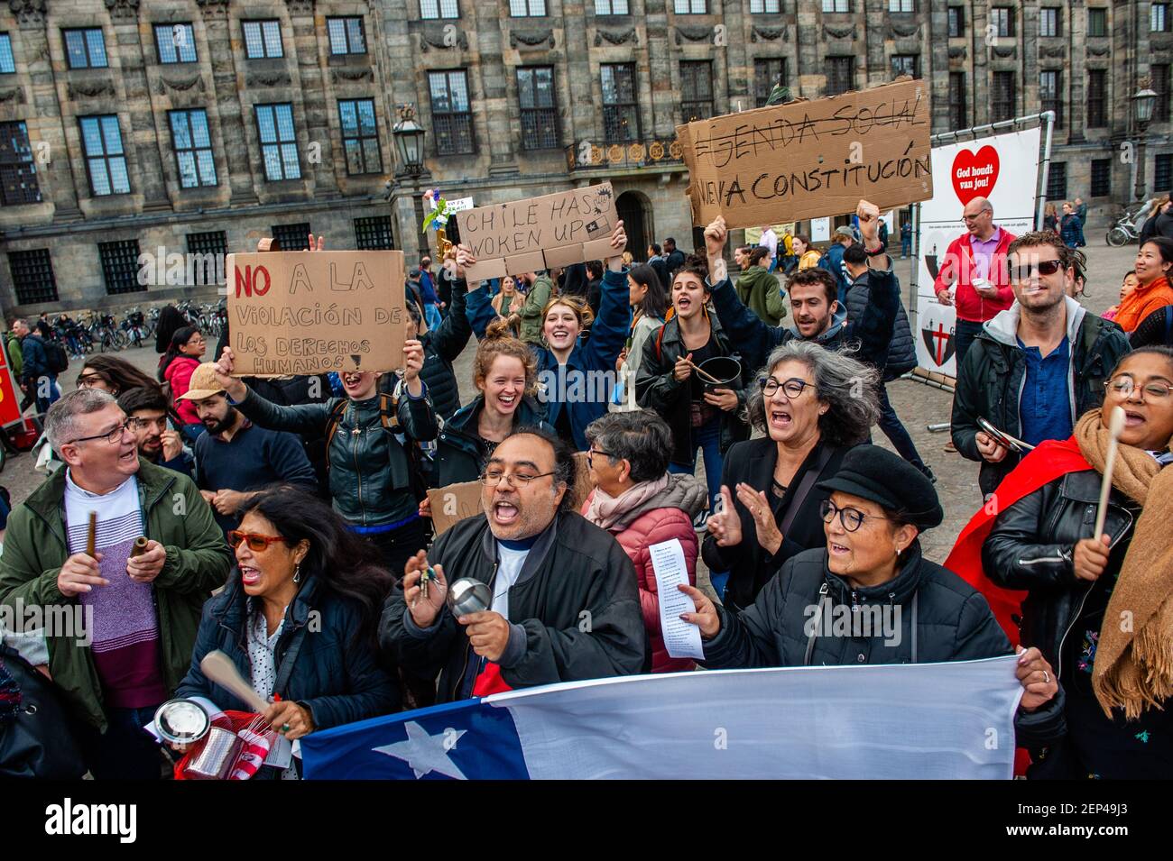 A group of Chilean people are seen jumping during the demonstration ...