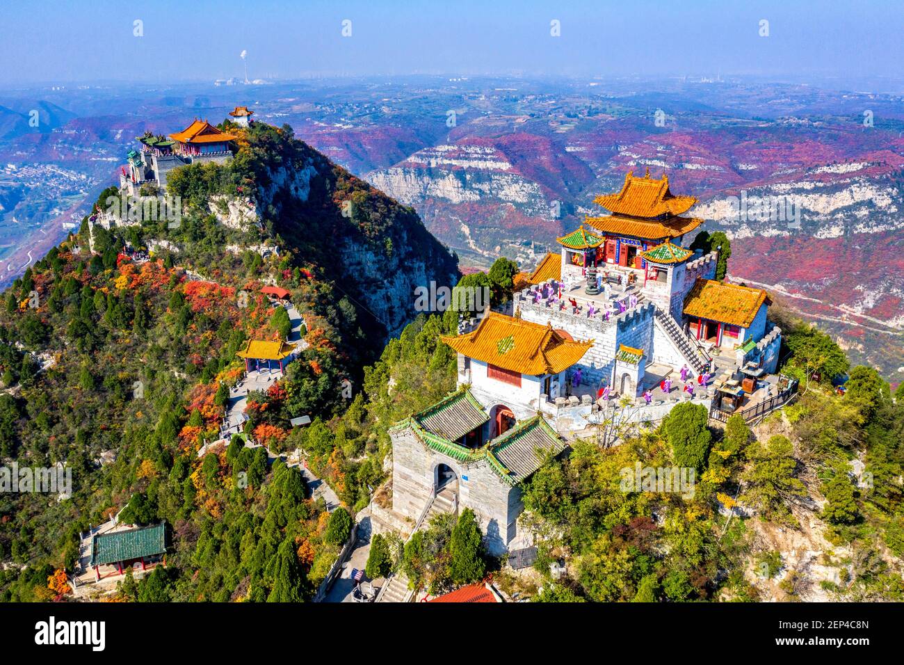 An aerial view of ancient buildings scattering among trees that ...
