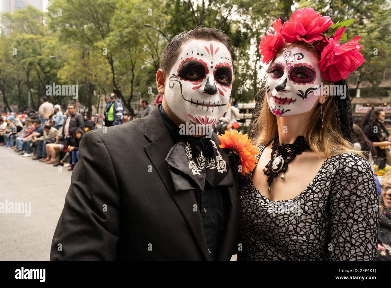 A couple post with their faces painted before the procession begins ...