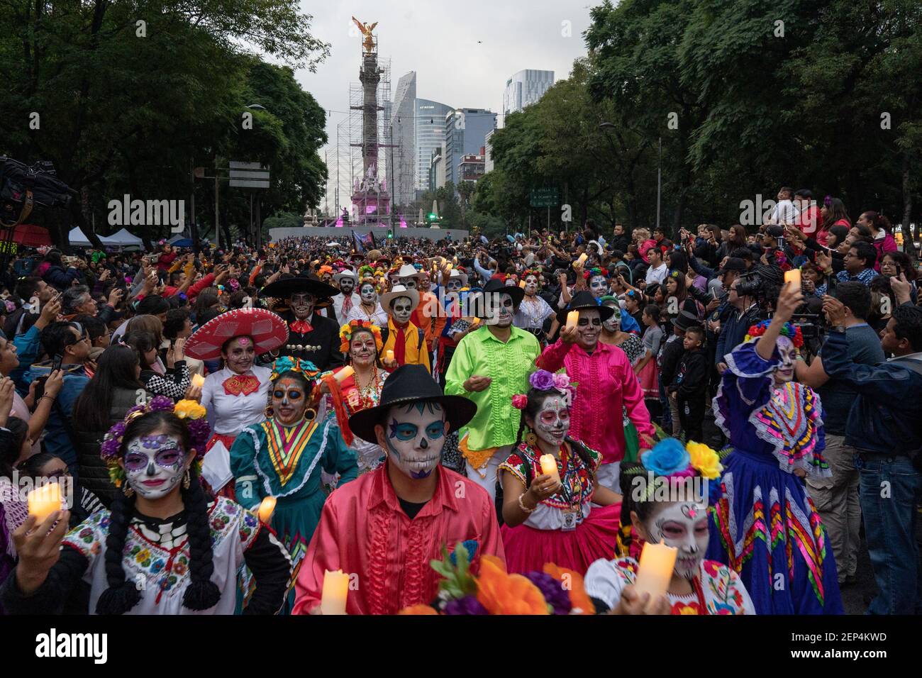 Several people in traditional costume and with their faces painted seen ...