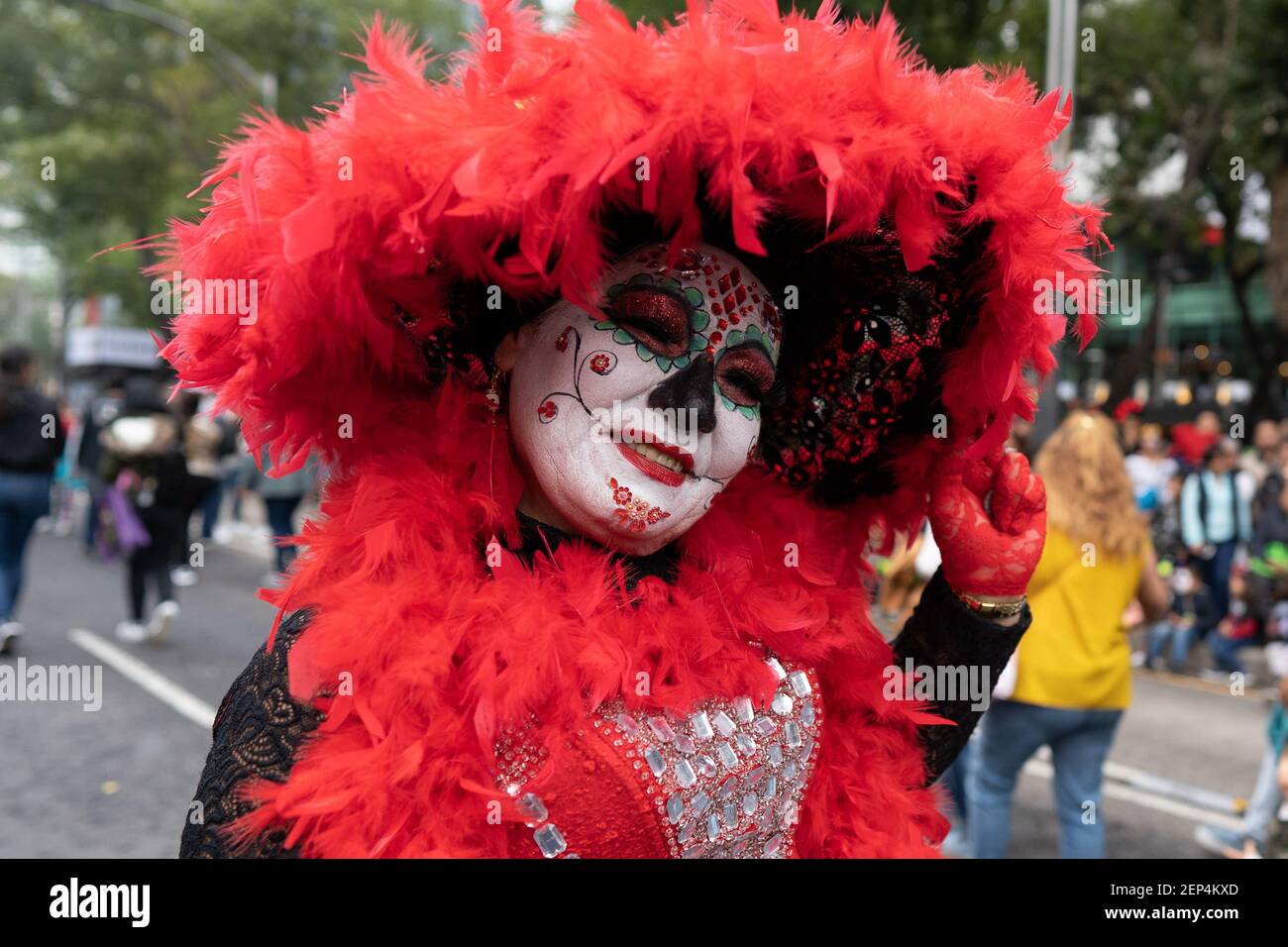 A woman in costume poses while waiting for the procession to begin ...