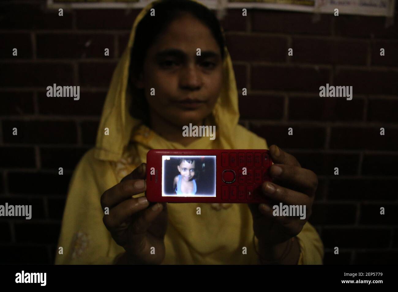 A women shows her nephew's photo who is missing after the explosion at ...