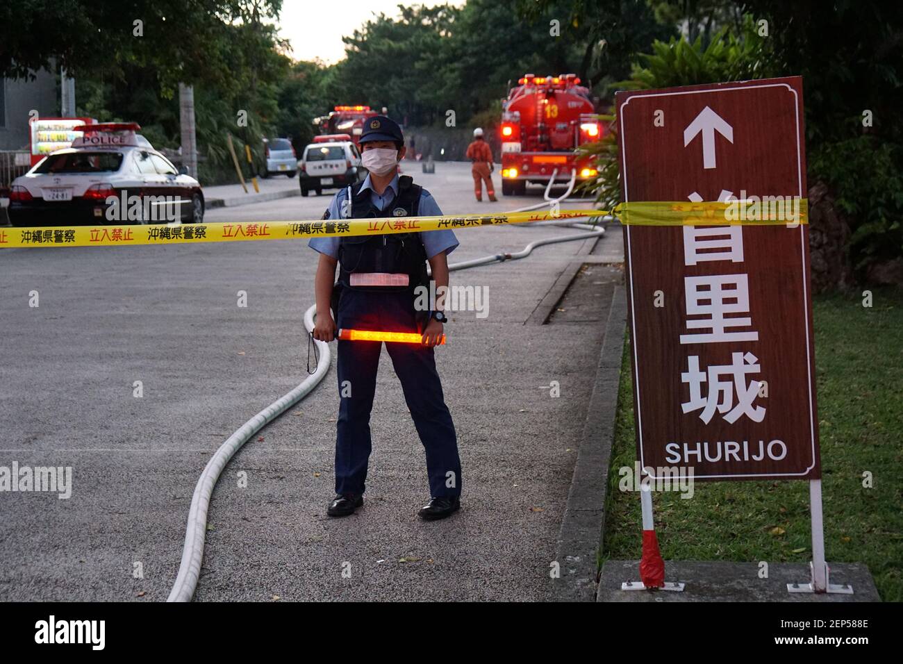 A police officer standing behind the limit line at the Shurijo castle ...