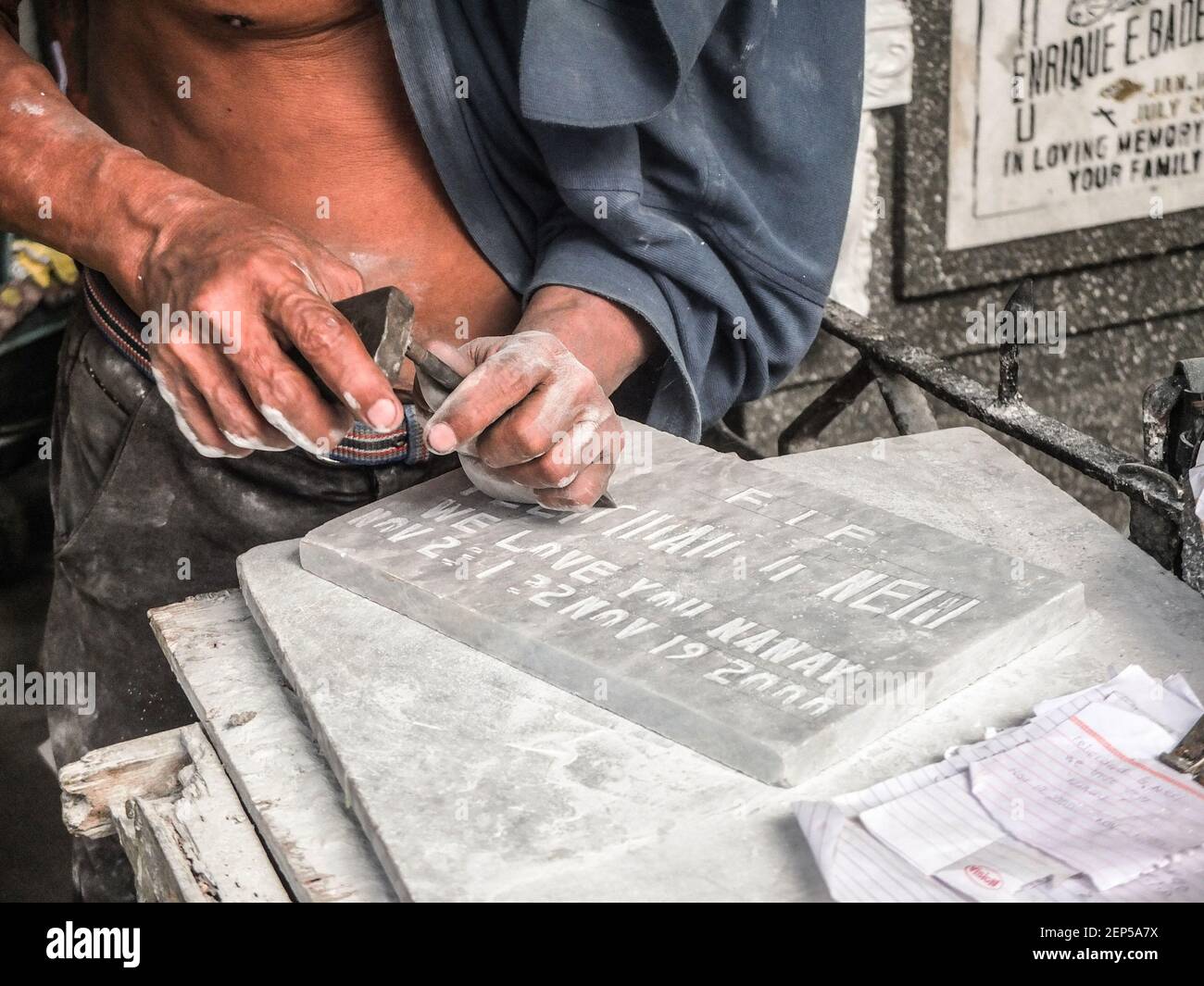 Mario Formales a grave stone maker makes his finishing touches ...