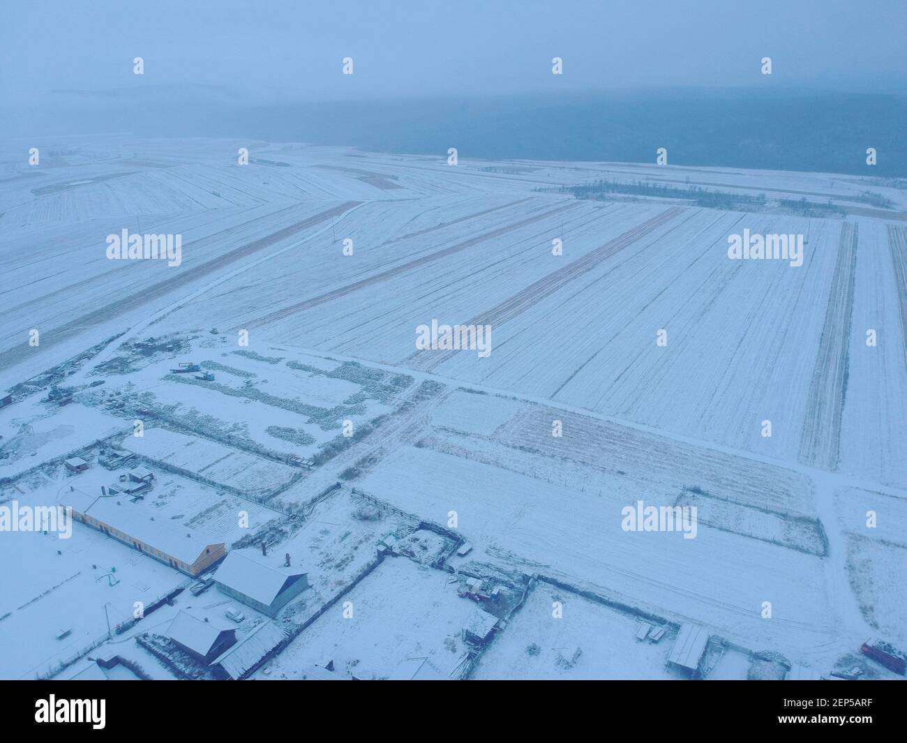 Aerial view of the snow-blanketed roads, streets and houses in Beihong ...