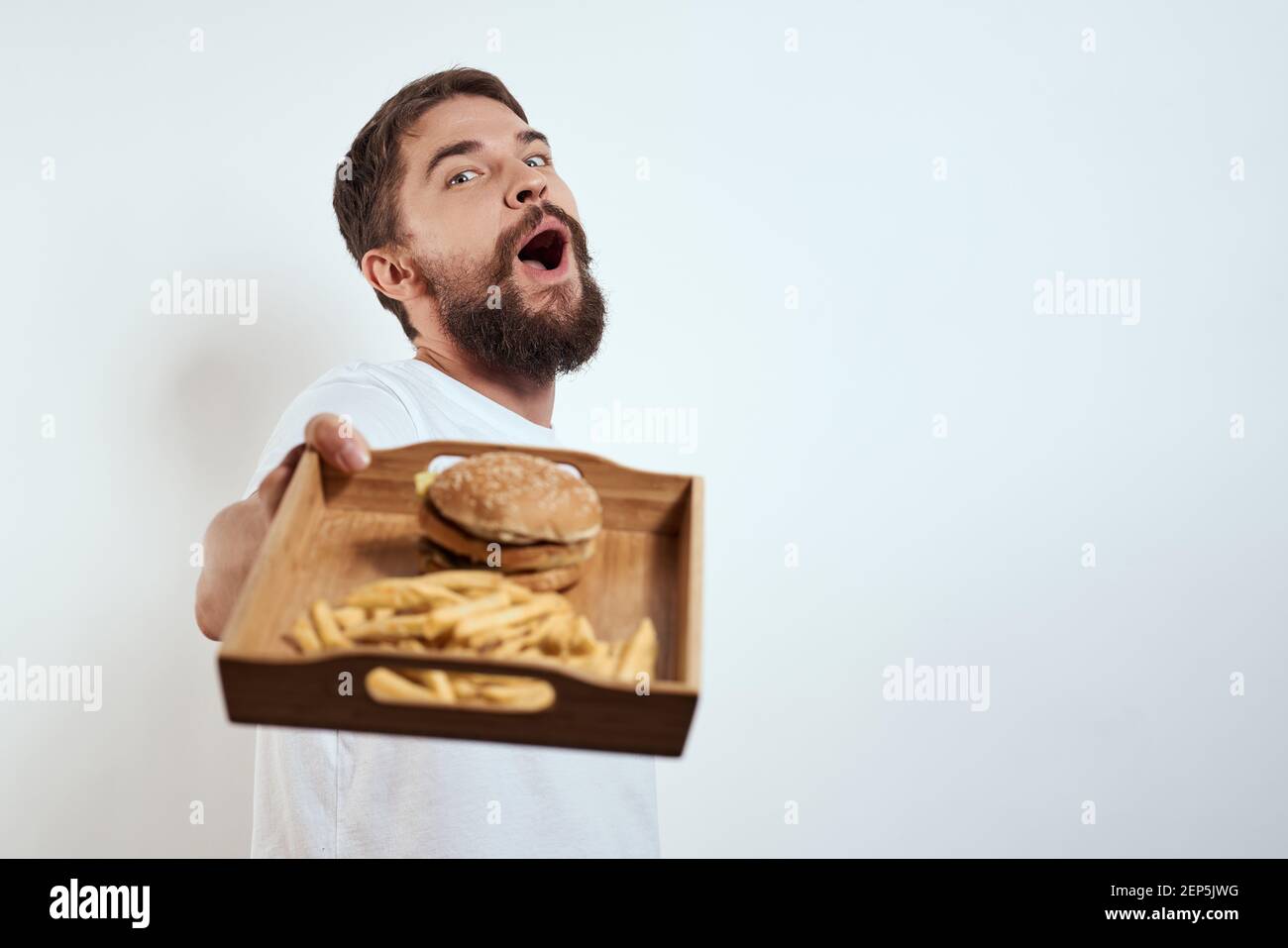Man with a mug of beer fast food diet food alcohol fun light background ...