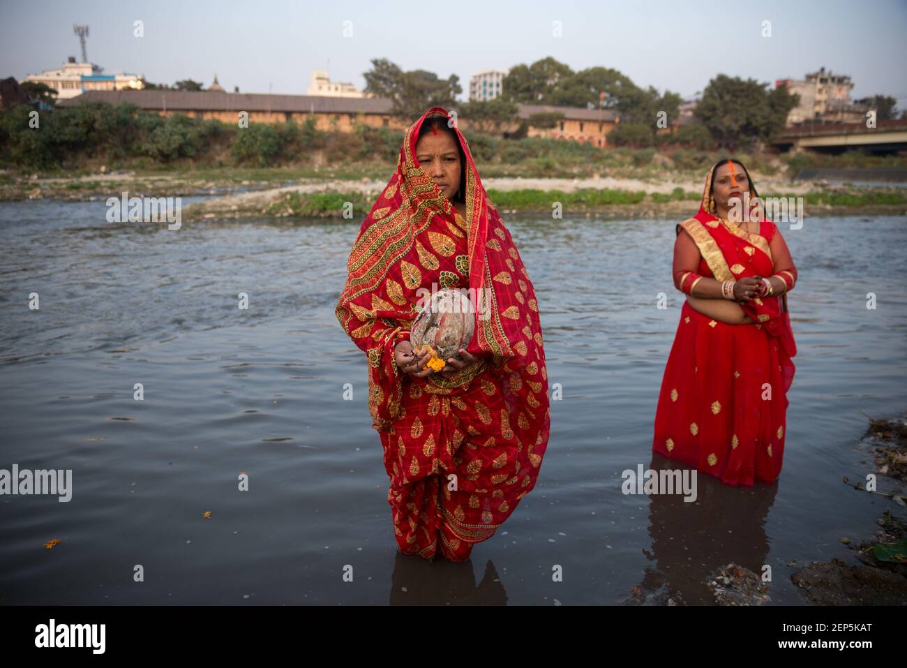 A devotee takes part in a ritual to worship the sun god during the ...