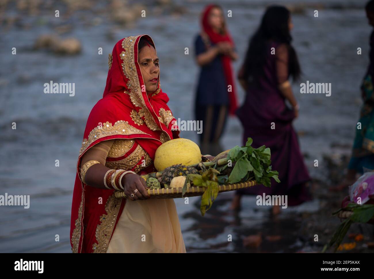 A devotee takes part in a ritual to worship the sun god during the ...