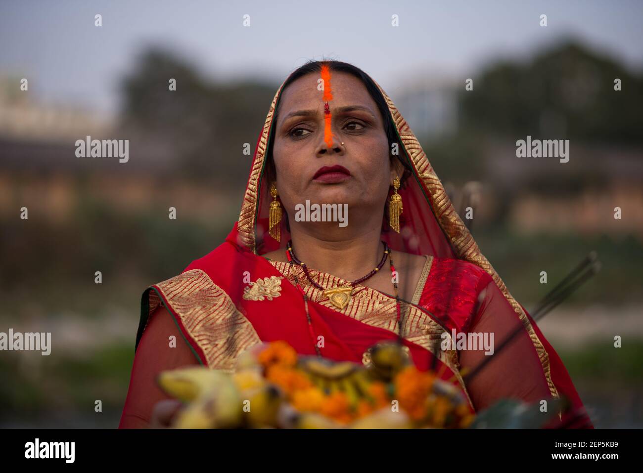 A devotee takes part in a ritual to worship the sun god during the ...
